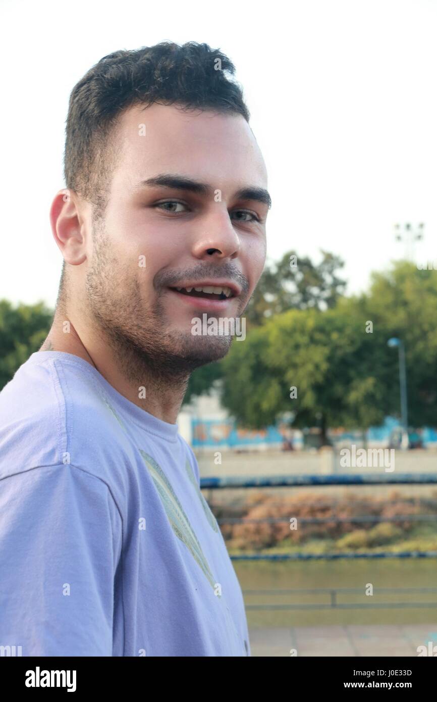 Handsome guy smiling at the camera Stock Photo - Alamy