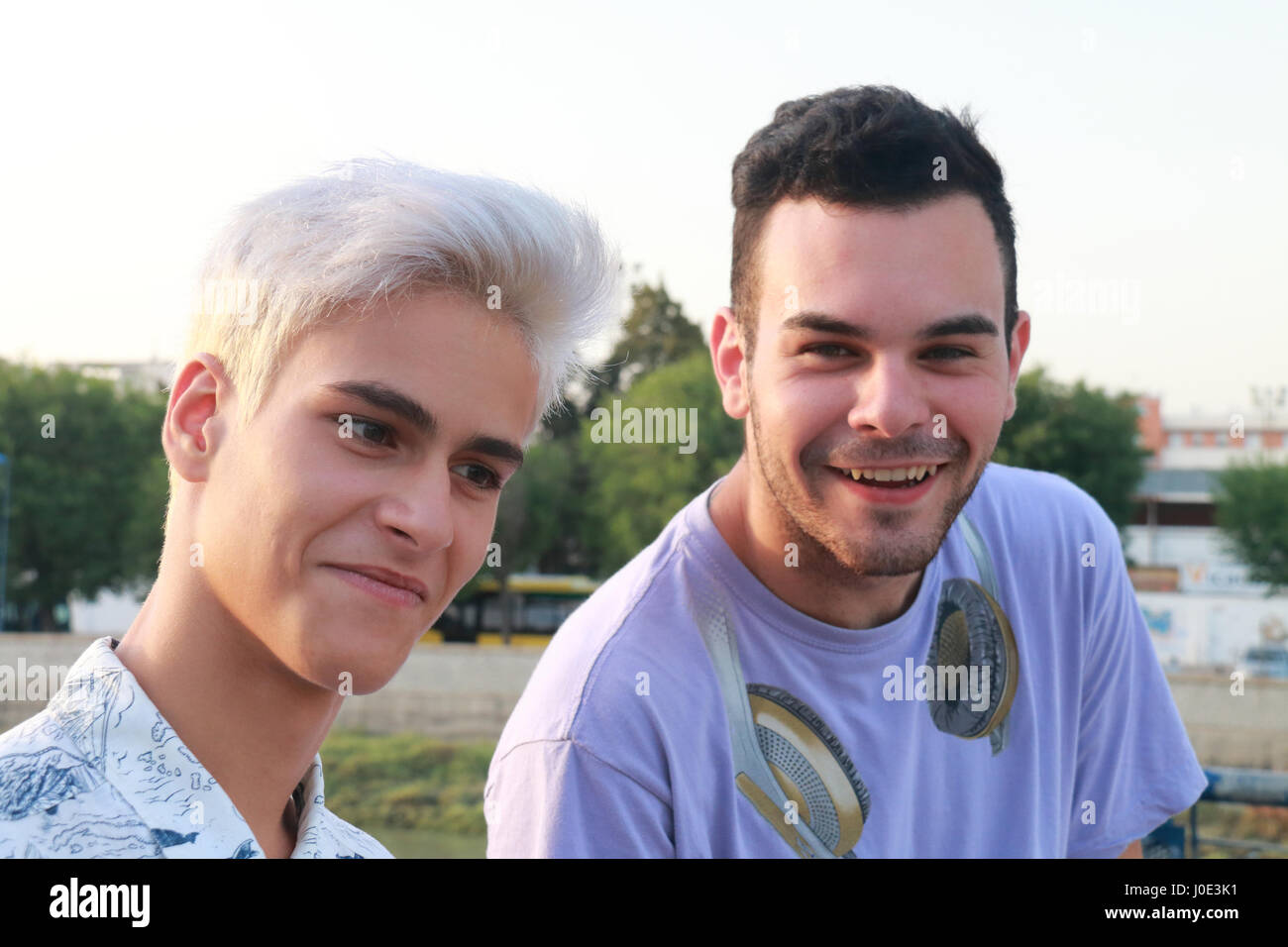 Portrait of two guys smiling to the camera Stock Photo - Alamy