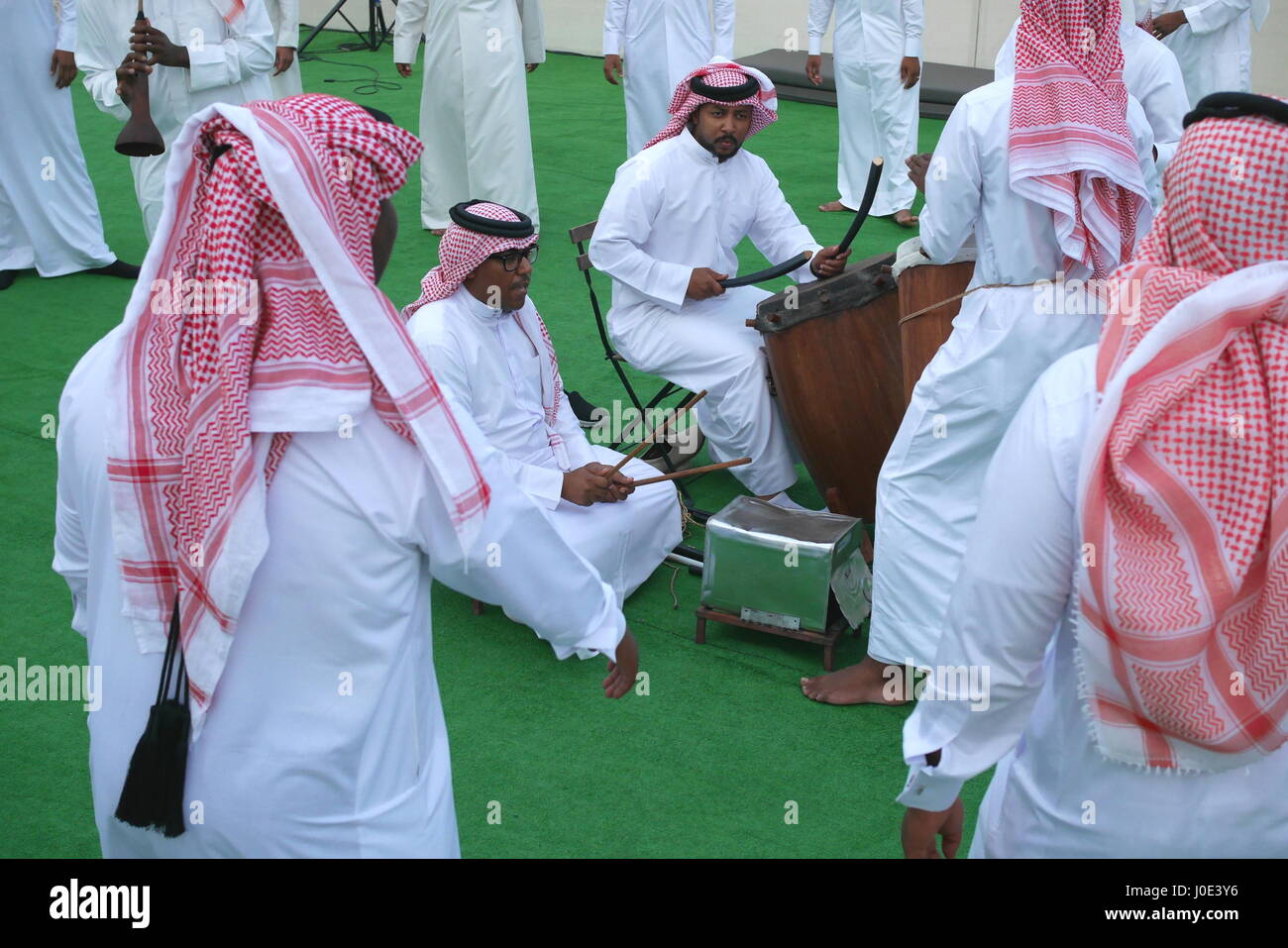 Traditional Bahrain dance accompanied by drums and mizmar. The men are ...