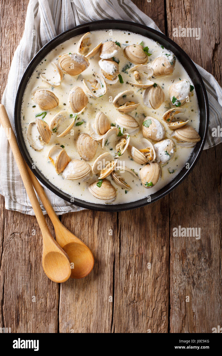 Delicatessen food: clams stewed in cream with garlic and greens close ...