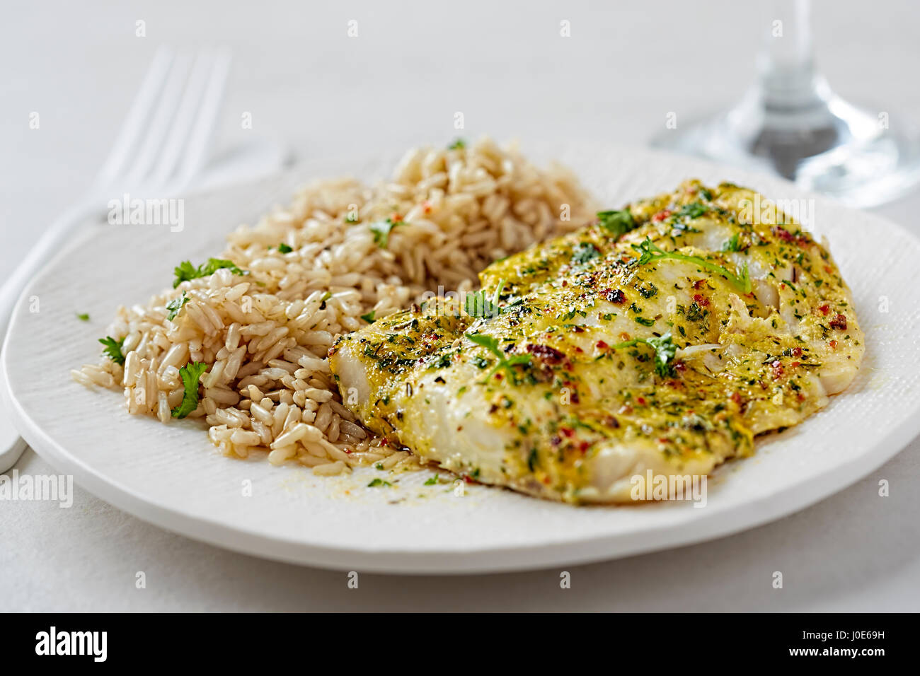 Cod with lemon garlic marinade rice Stock Photo - Alamy