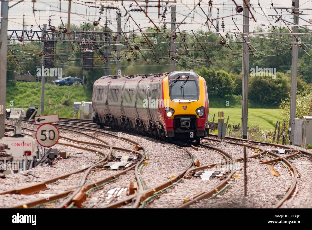Virgin Voyager diesel train on the West Coast Main Line at Winwick ...