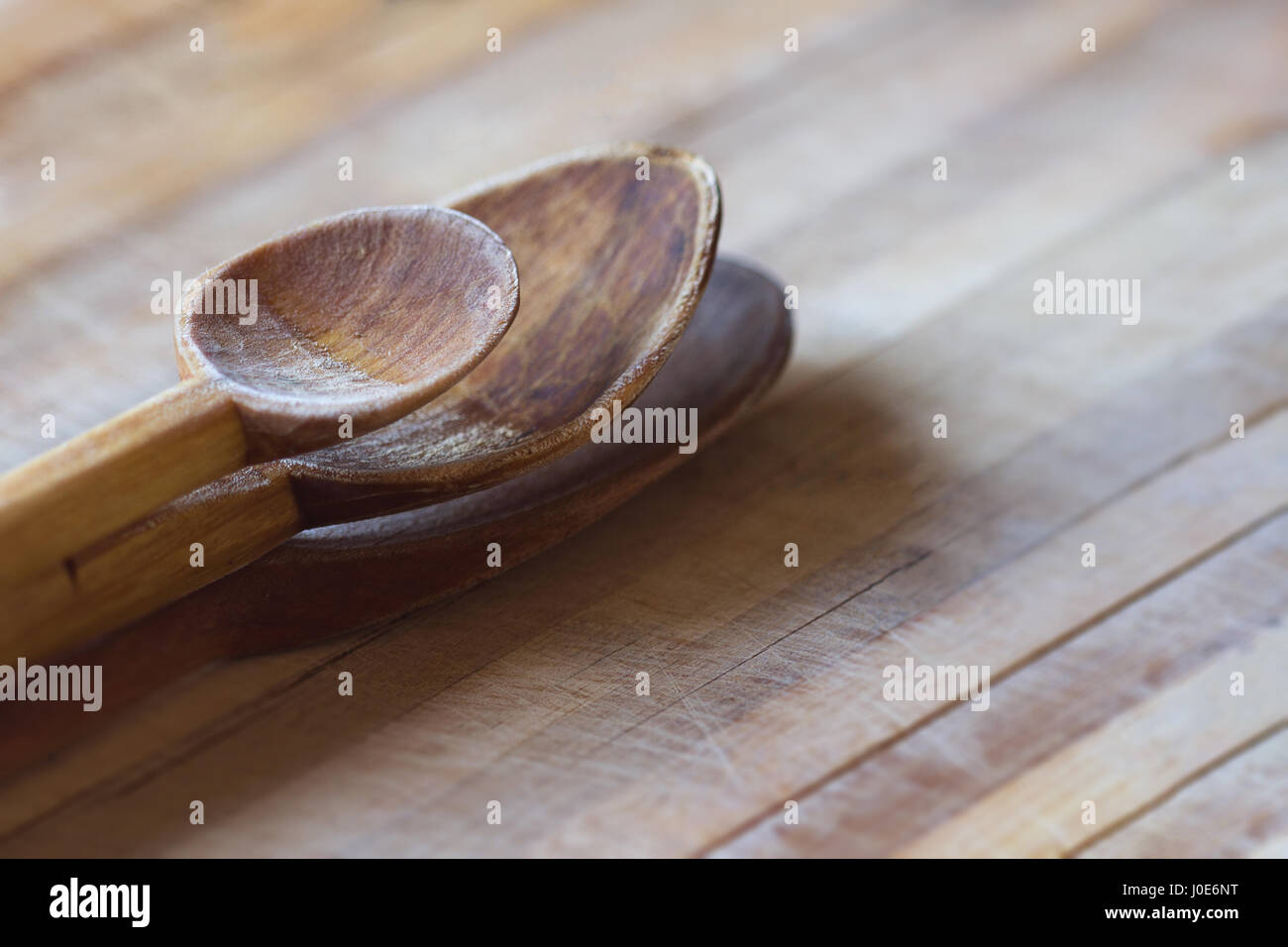 side view of hand crafted wooden kitchen spoons in many sizes and ...