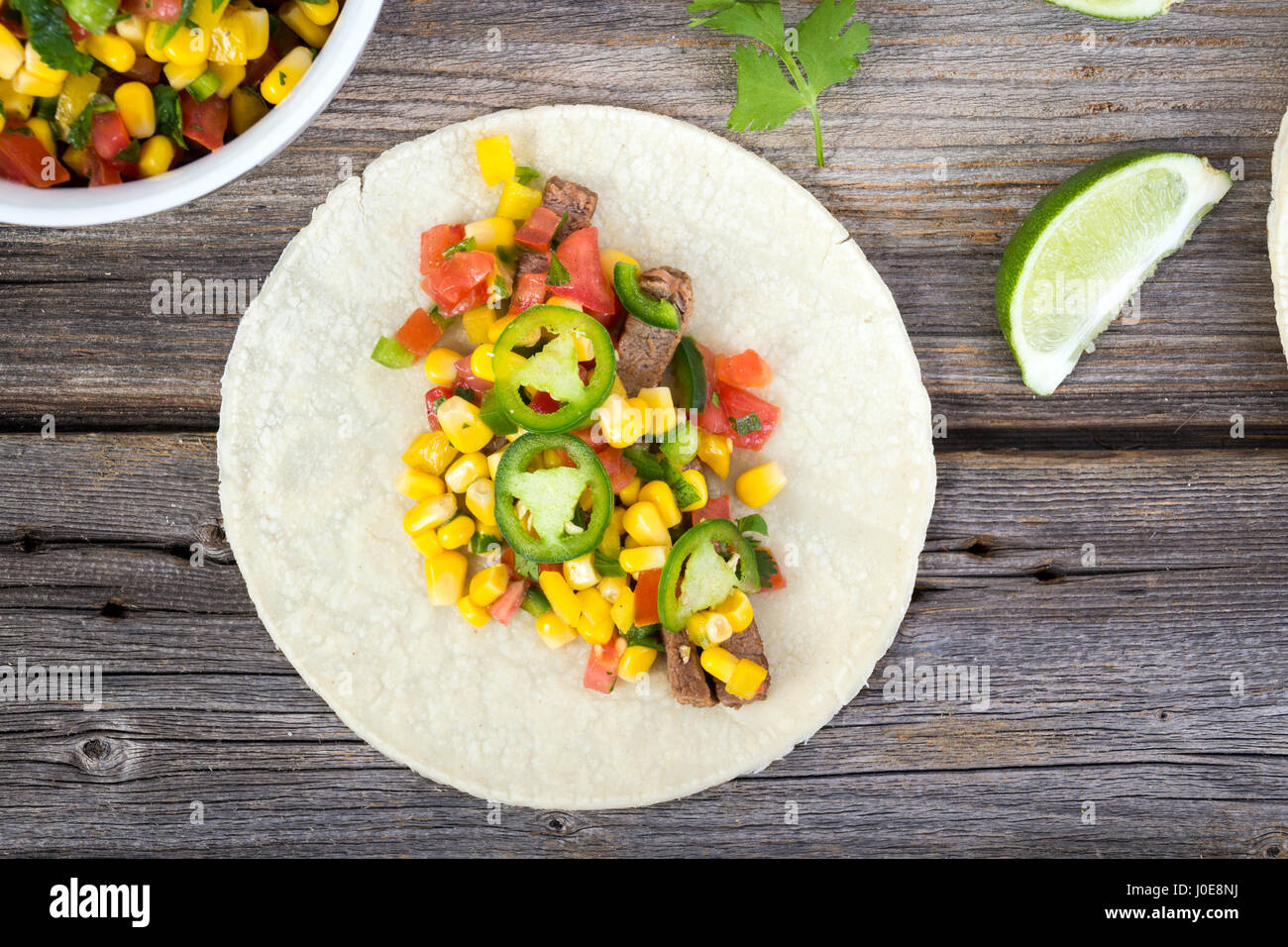 beef corn soft taco on rustic wood table with corn salsa Stock Photo ...