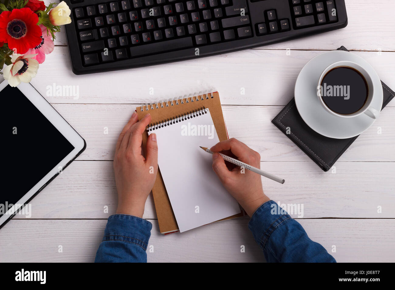 female hands writing in a notepad view from above Stock Photo - Alamy