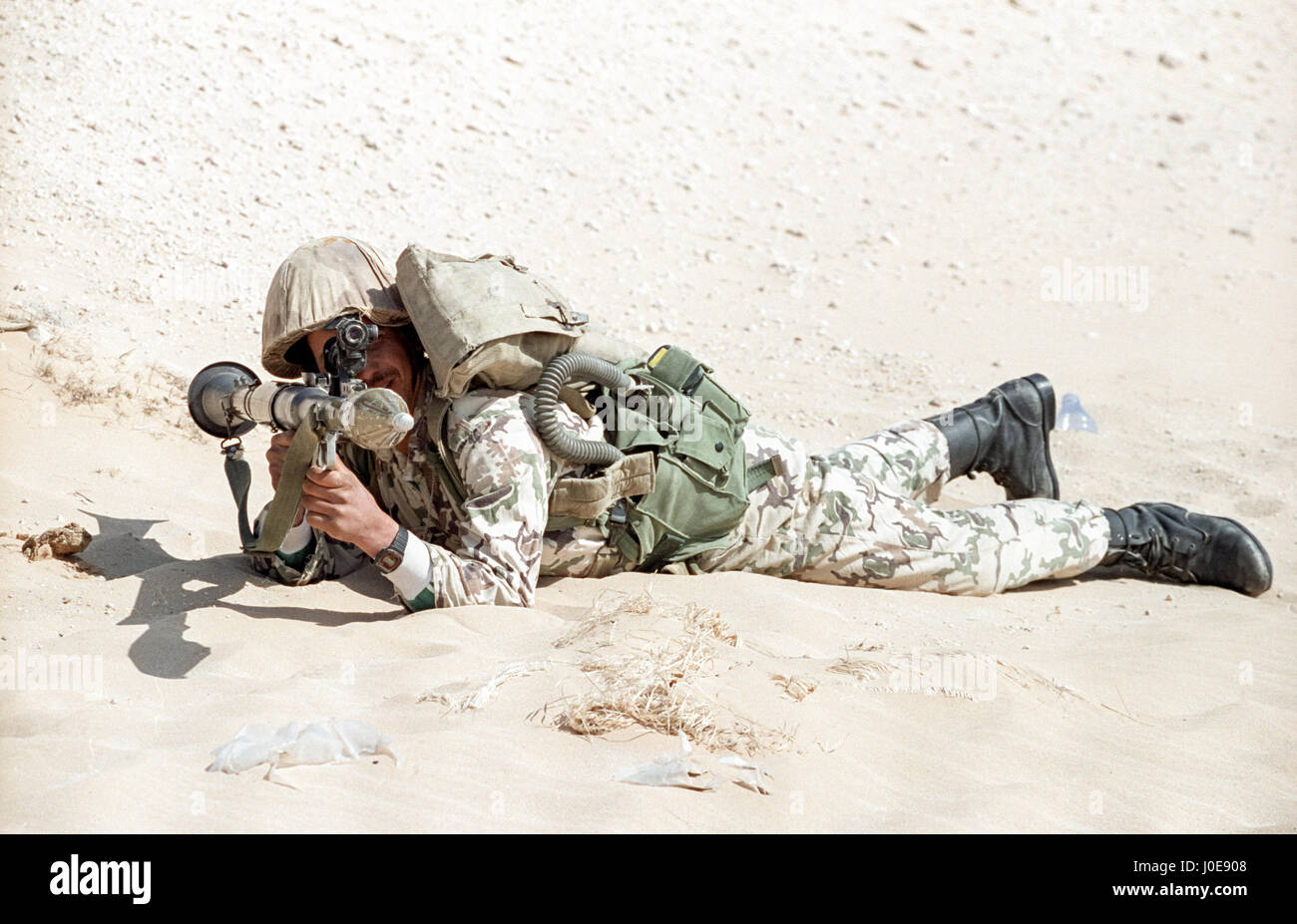 An Egyptian soldier patrols the sand berm marking the border of Kuwait ...