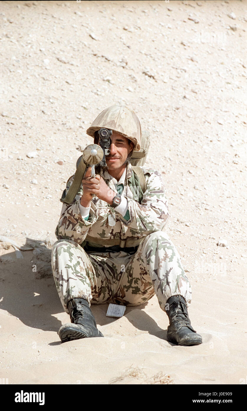 An Egyptian soldier patrols the sand berm marking the border of Kuwait ...