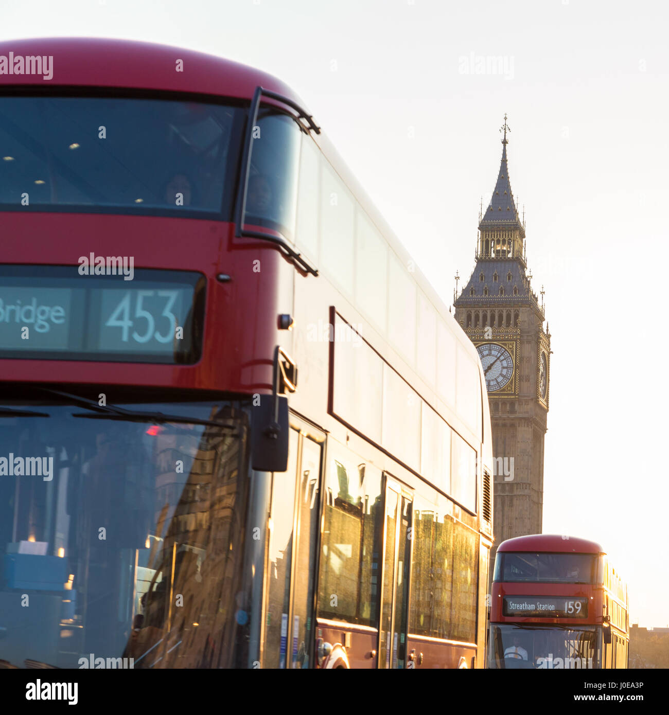 Traditionally red double-decker buses passing on Westminster Bridge in ...