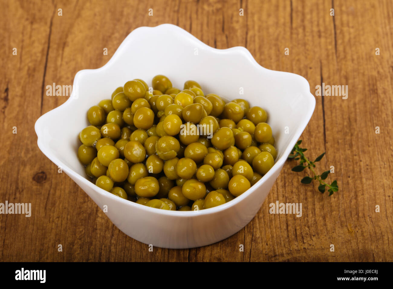 Pickled pea in the plate over wooden background Stock Photo - Alamy
