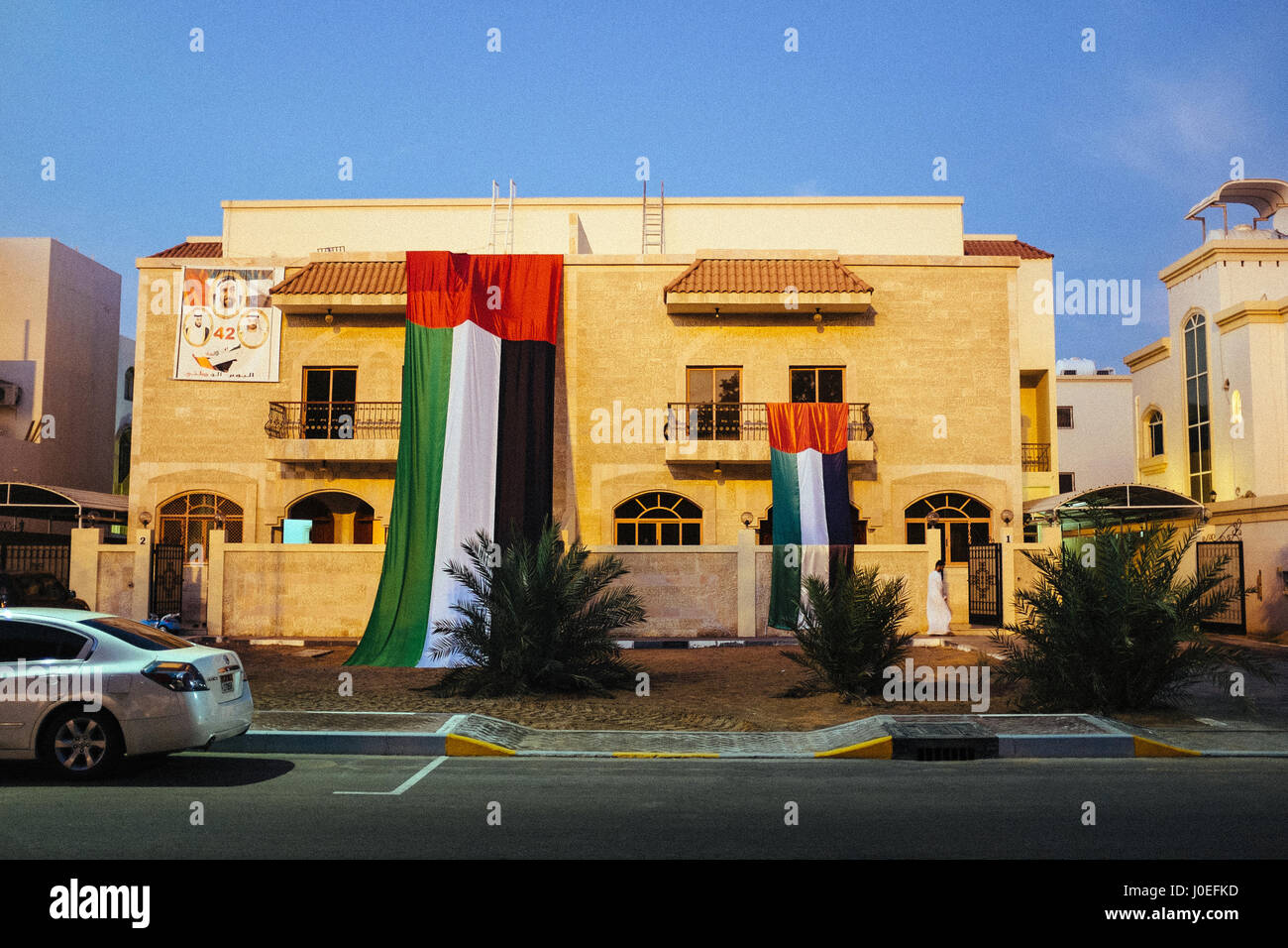 The flags of the United Arab Emirates are hanging on a house to mark ...