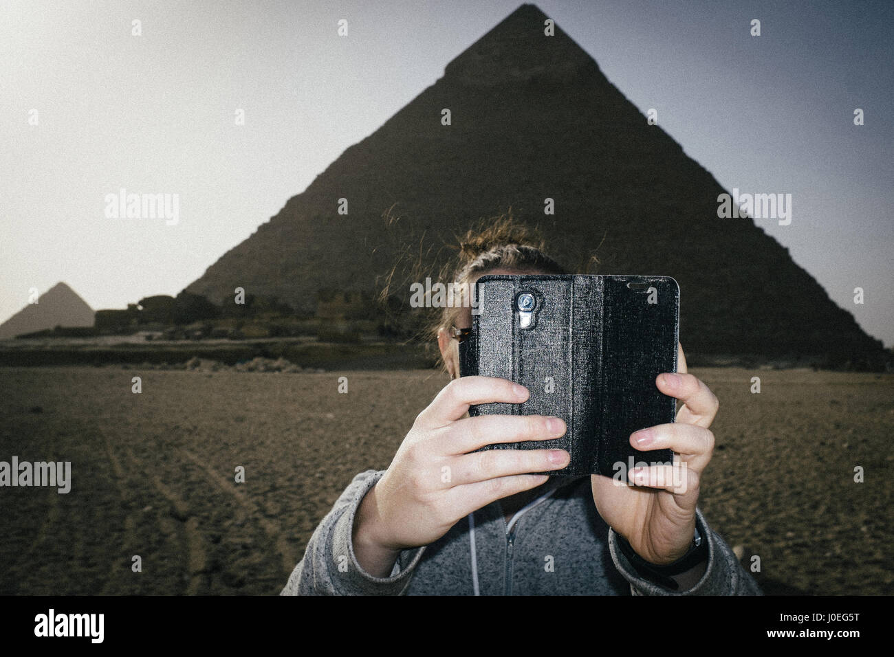 Woman takes a "selfie" in front of the Pyramid of Khafre in Giza, Egypt ...