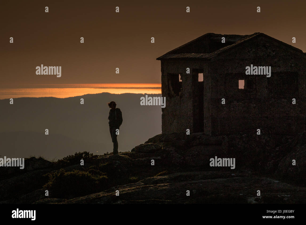 Woman thinking at sunset Stock Photo - Alamy