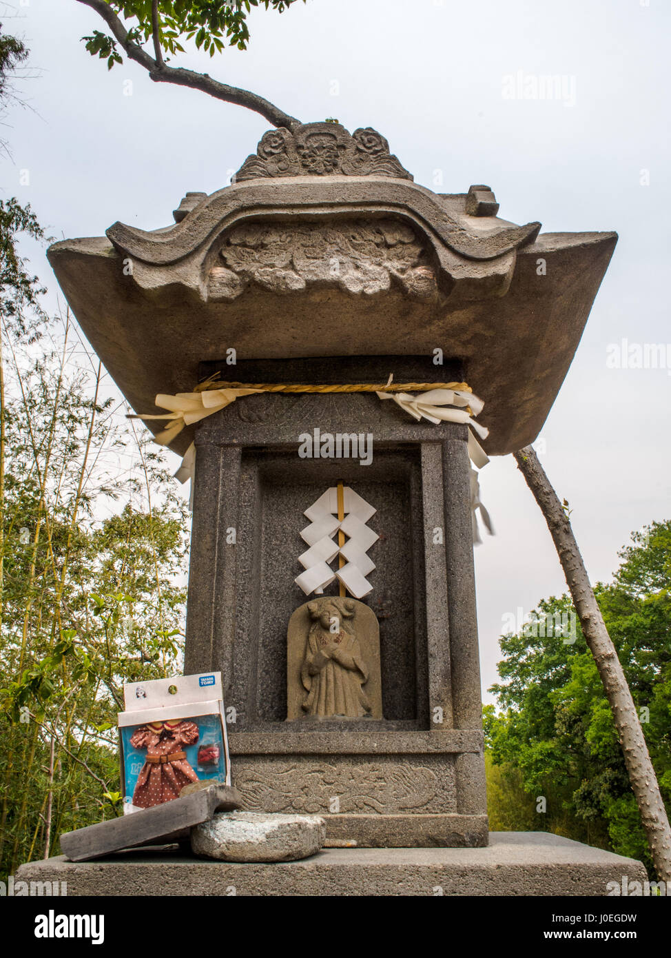 Shinto shrine with feminine deity, white paper shide and with offering ...