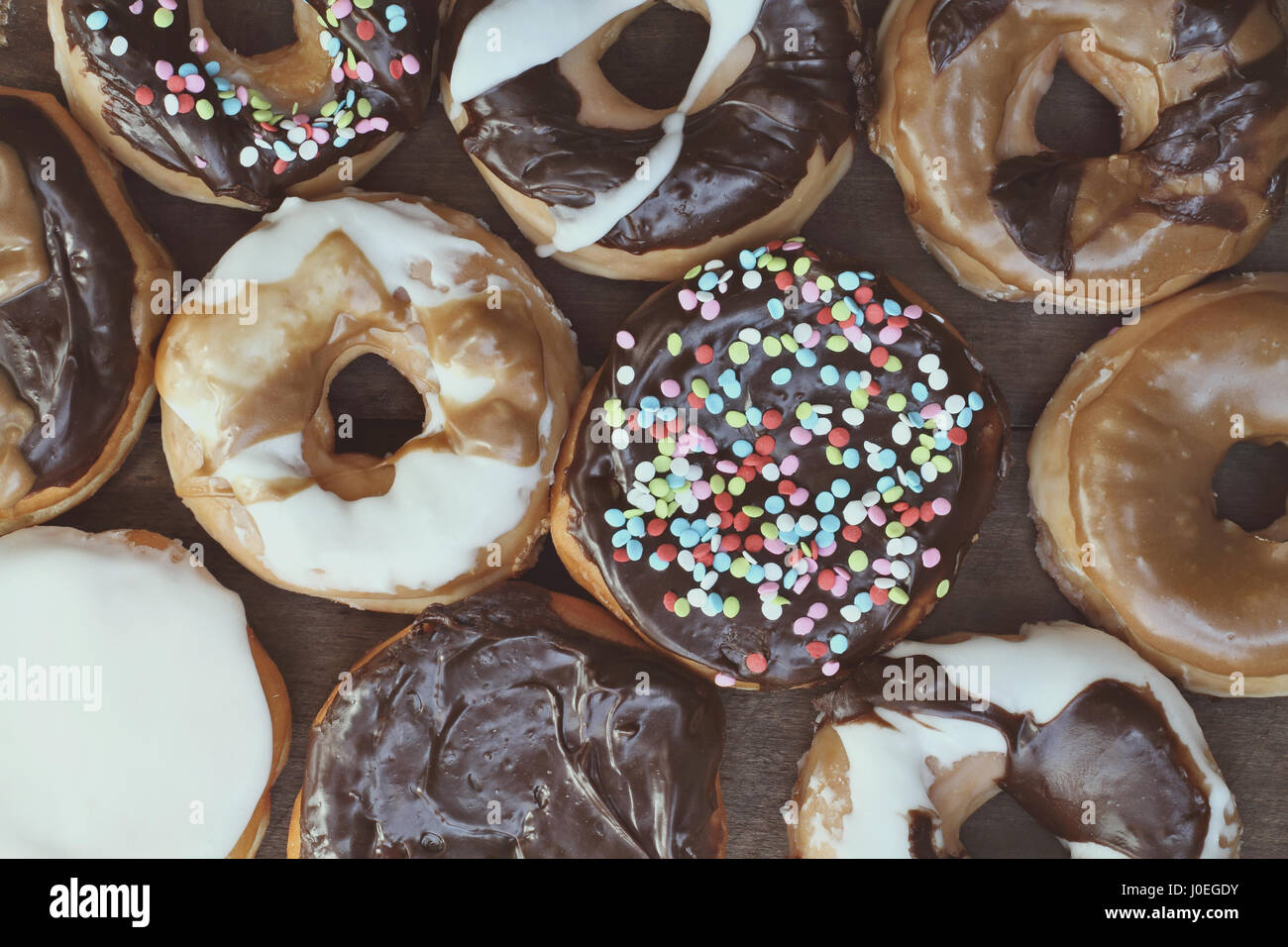 Variety of fresh donuts over rustic background. Image shot from ...