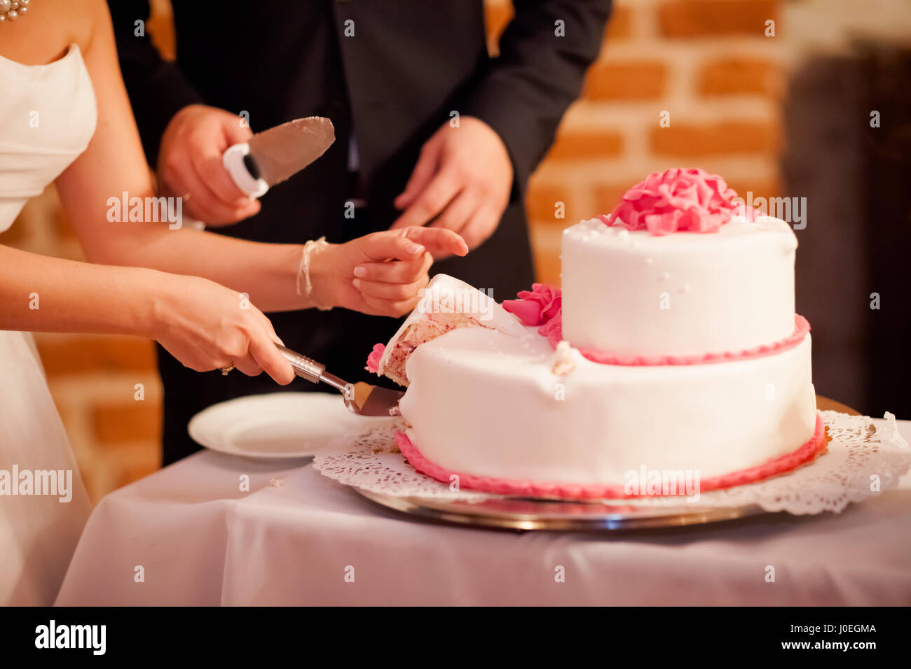 Beautiful wedding cake detail. Traditional first slice cutting by Bride ...