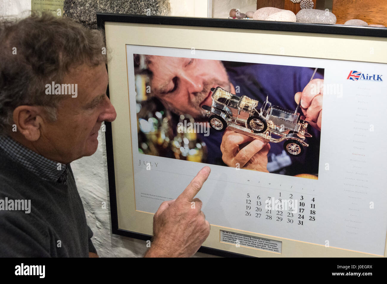Bruce Russell, a highly skilled gold & silversmith holding a framed ...