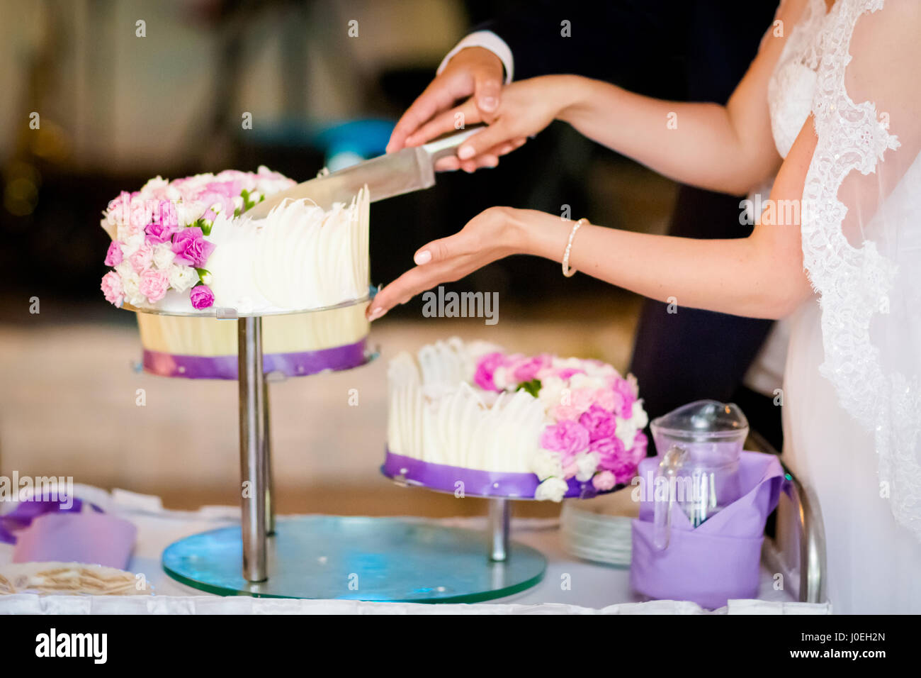 Beautiful wedding cake detail. Traditional first slice cutting by Bride ...