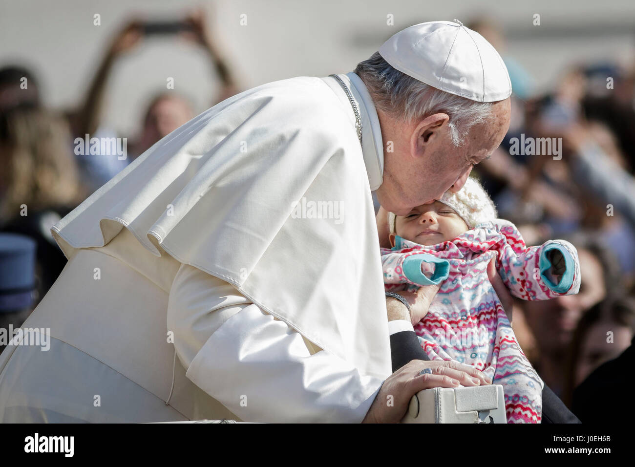 Pope Francis kisses a baby as he arrives to celebrate his Weekly ...