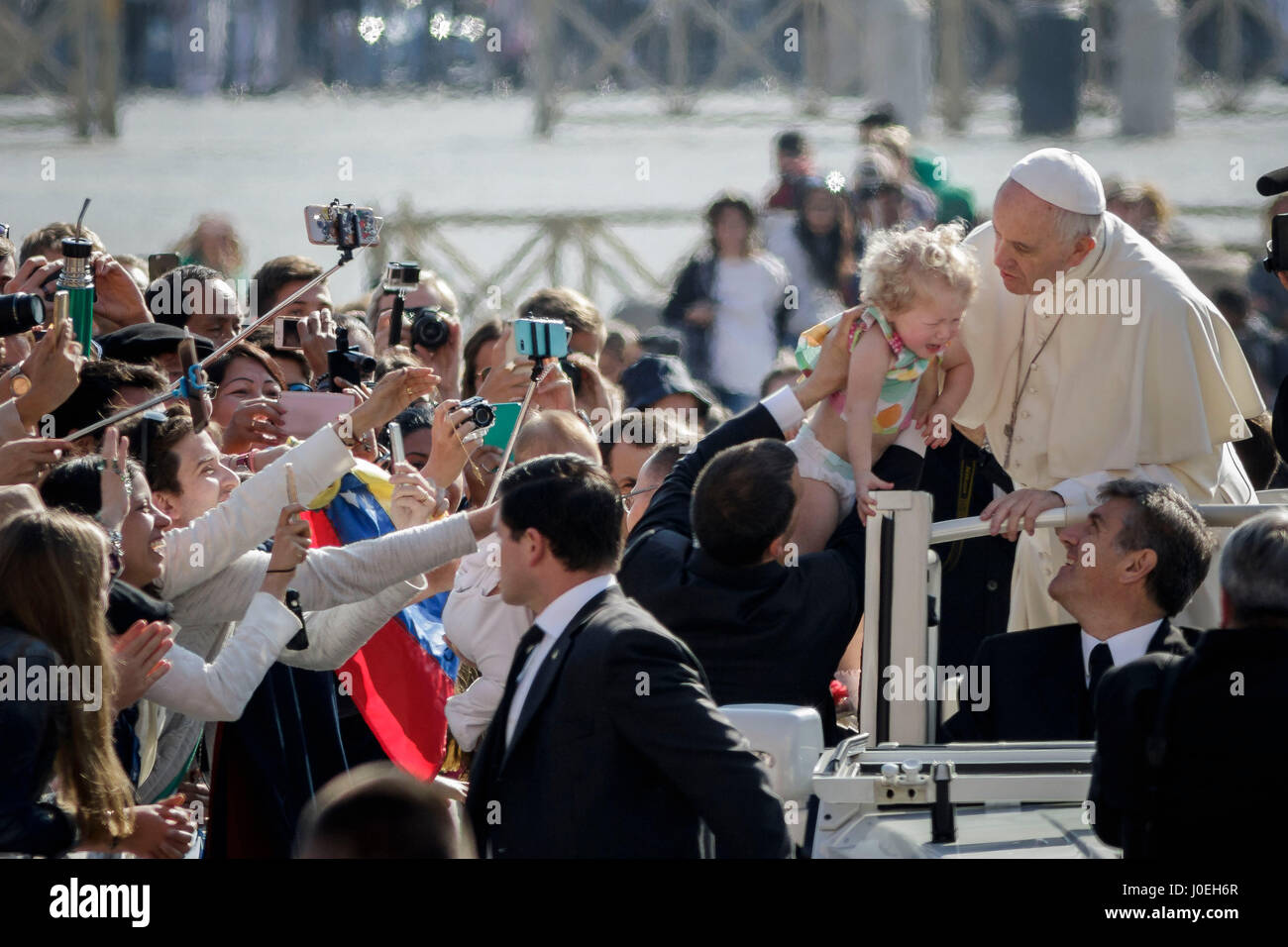 Pope Francis kisses a baby as he arrives to celebrate his Weekly ...