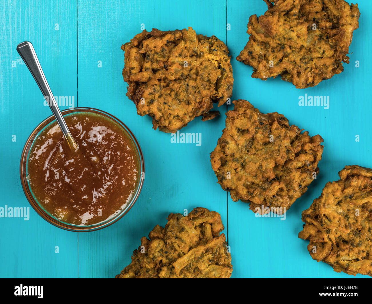 Onion Bhajis With Mango Chutney Against a Blue Background Against a ...