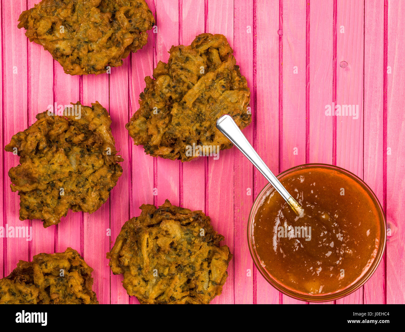 Onion Bhajis With Mango Chutney Against a Pink Background Stock Photo ...