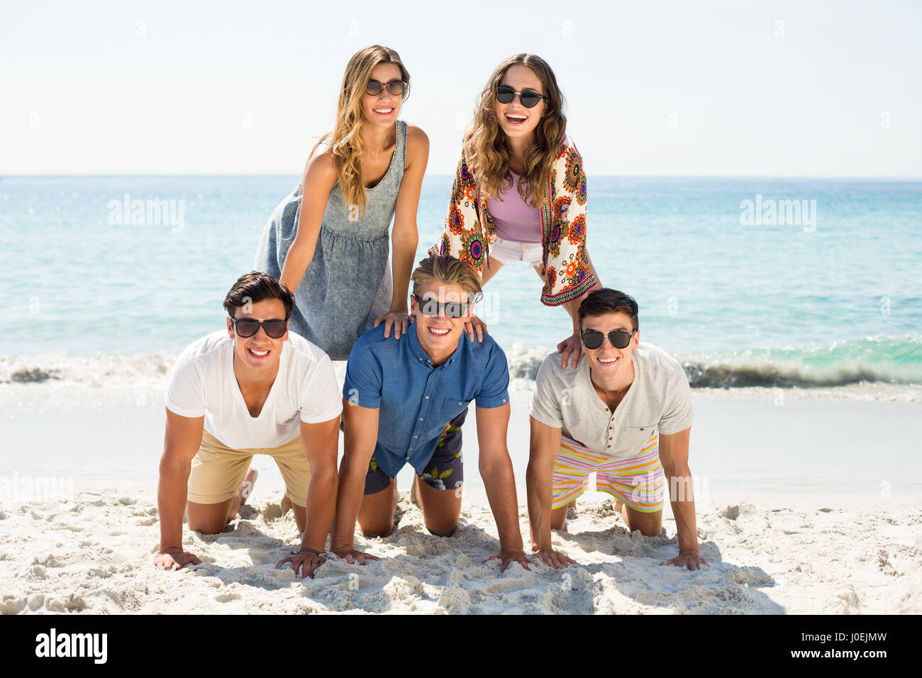 Human pyramid on beach hi-res stock photography and images - Alamy