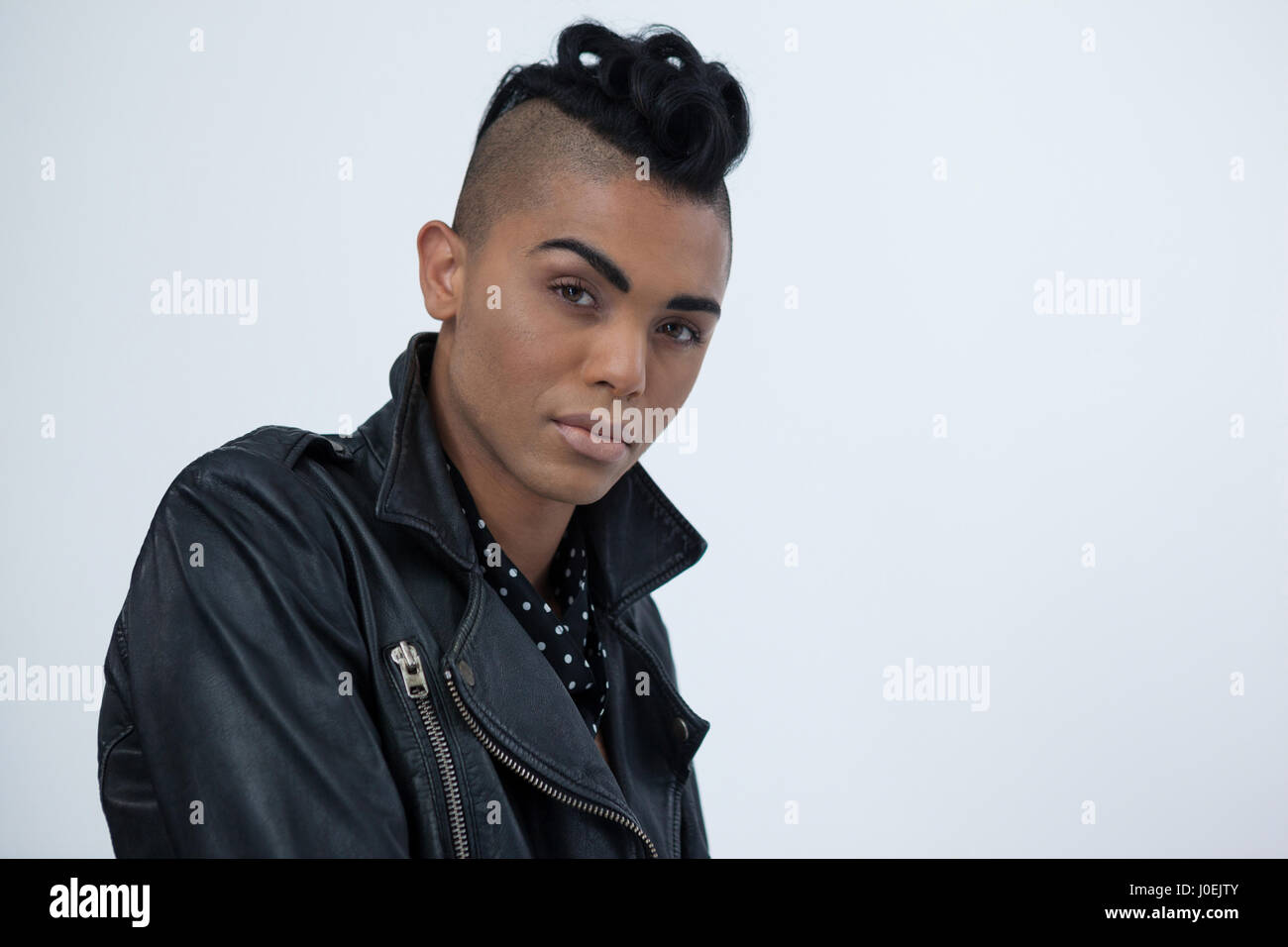 Portrait of transgender woman standing against white background Stock ...