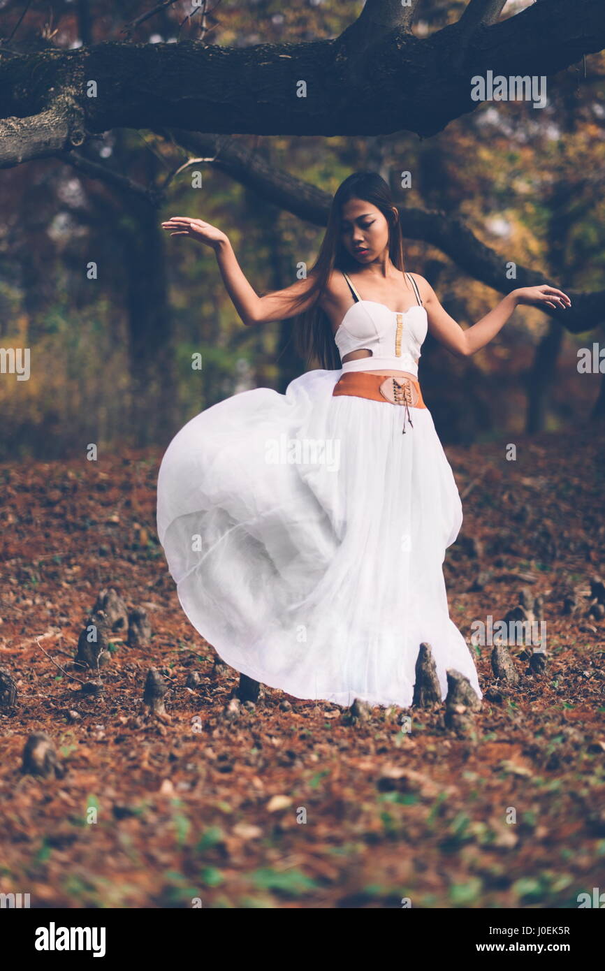 Beautiful wiccan girl dancing in the mystical forest Stock Photo - Alamy