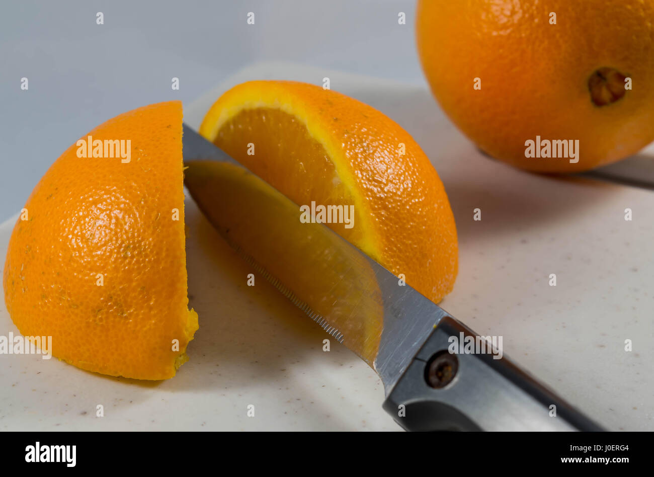 Slicing an orange Stock Photo - Alamy