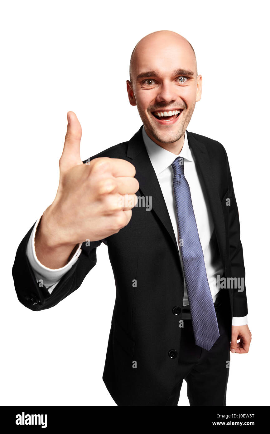 Studio shot of happy young businessman shows his thumb. Isolated on ...