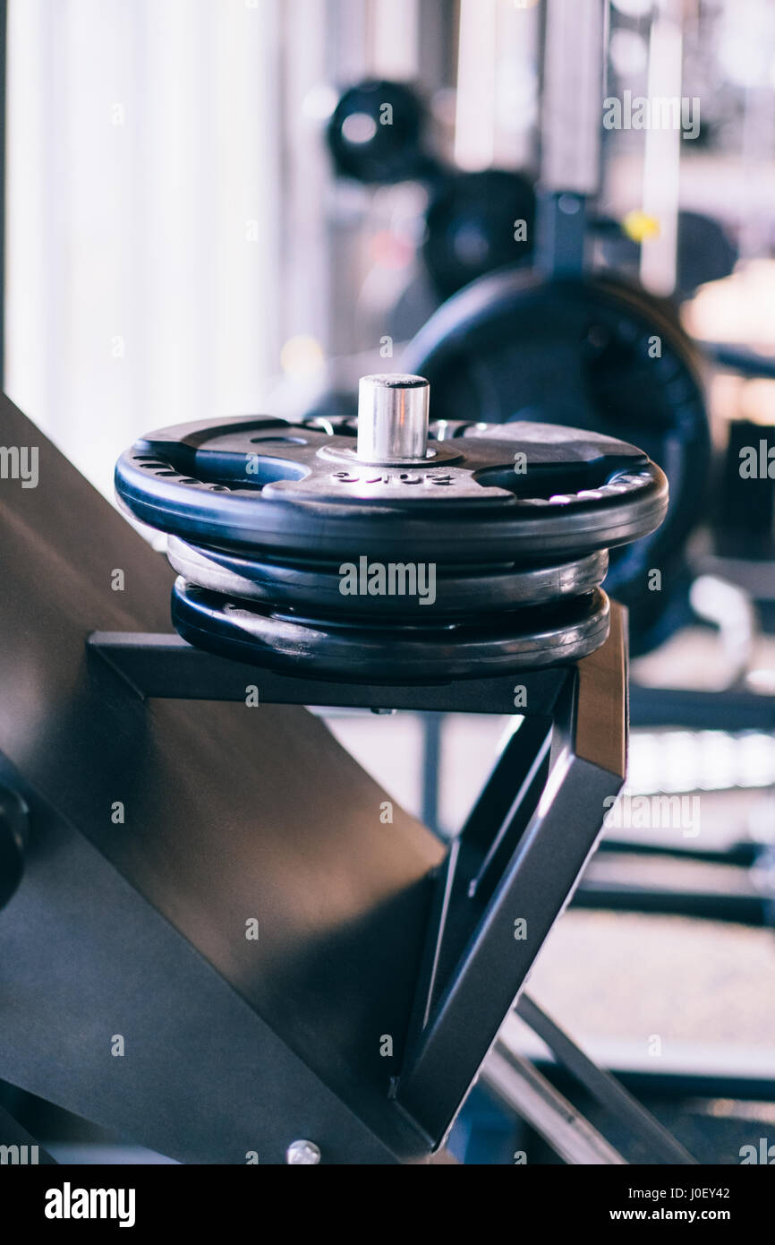 Set of metal barbells disks on barbbell holder in the fitness gym Stock ...