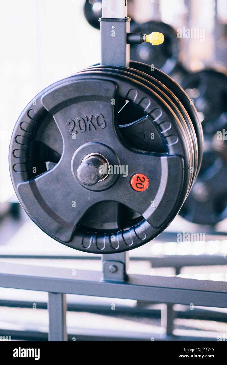 Set of metal barbells disks on barbbell holder in the fitness gym Stock ...