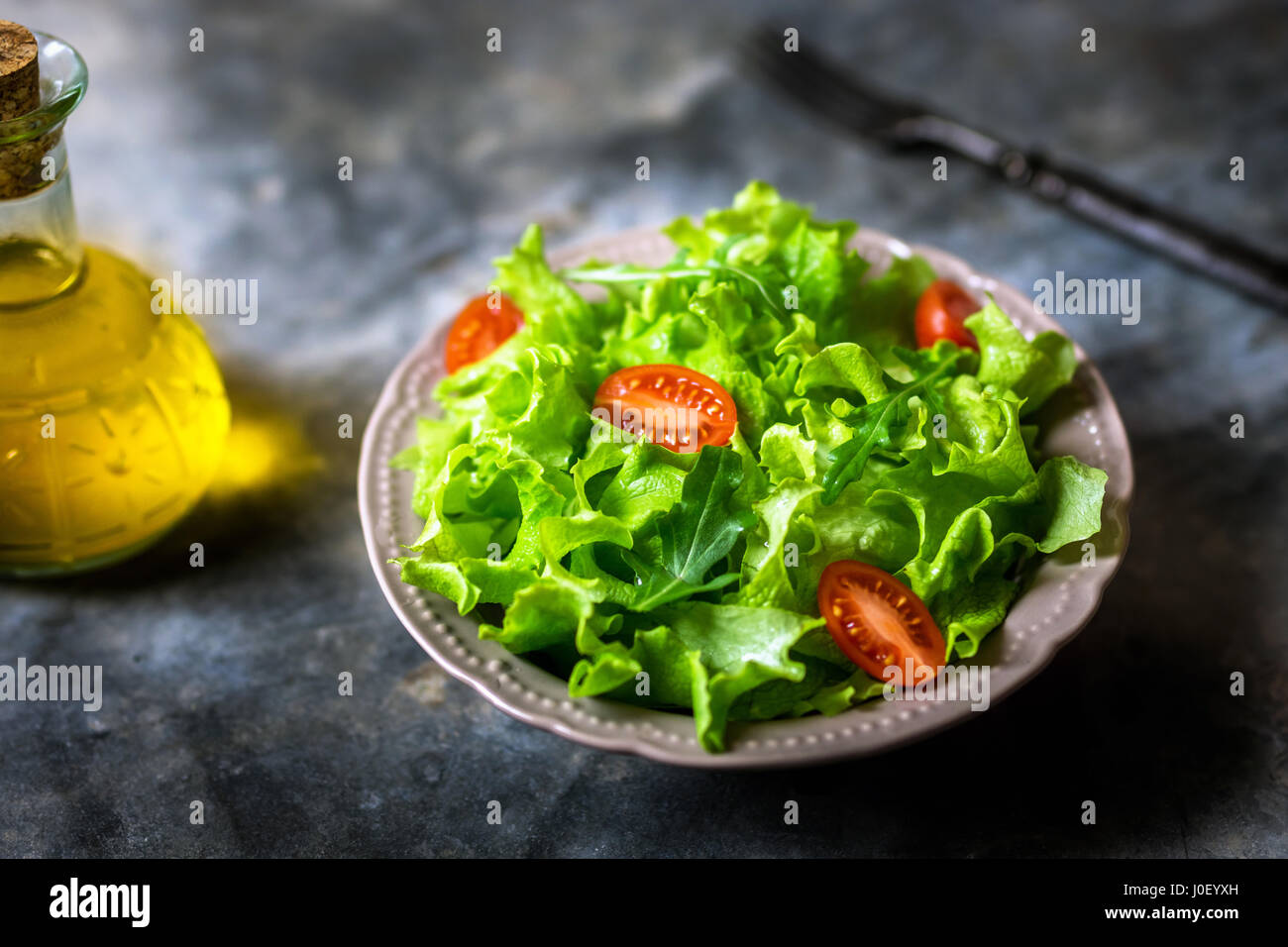 Fresh green salad on rustic background Stock Photo - Alamy