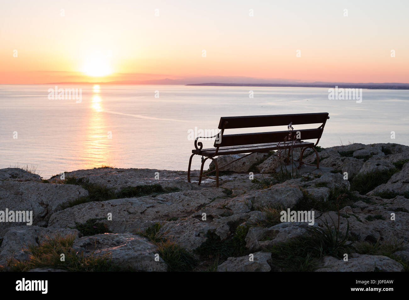 Sunset beach and bench Stock Photo - Alamy