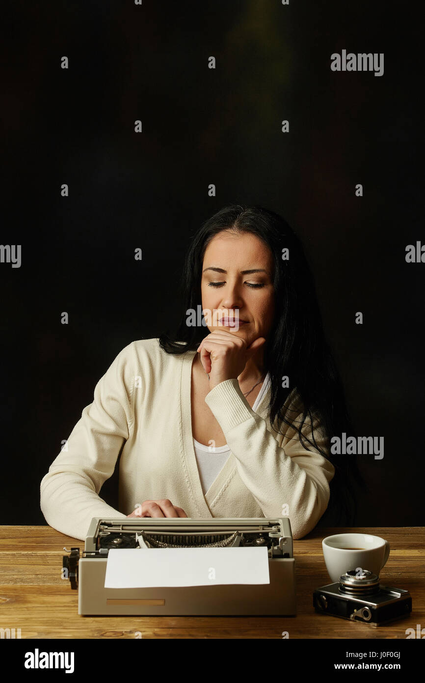 Woman writing on a typewriter Stock Photo - Alamy