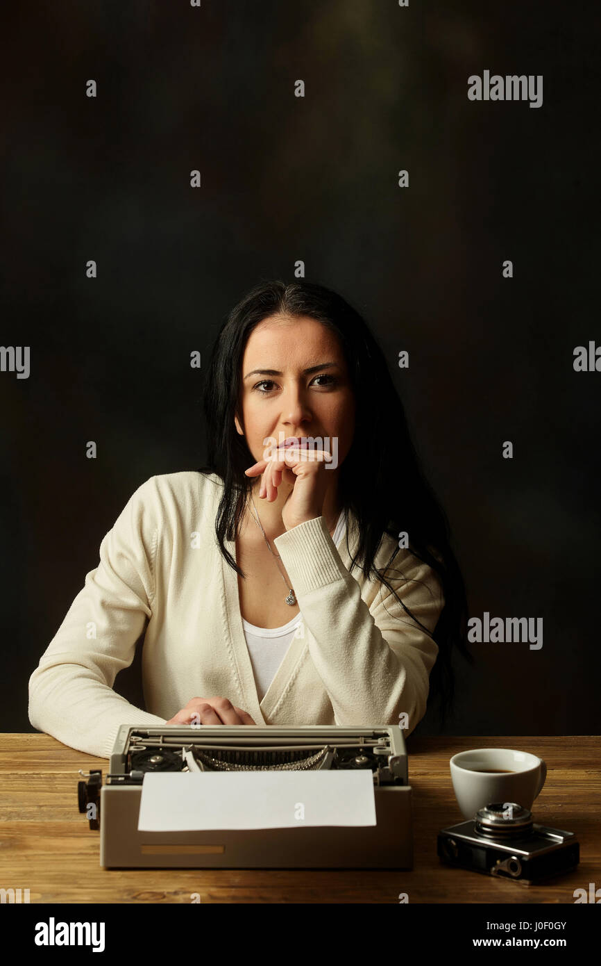 Woman writing on a typewriter Stock Photo - Alamy