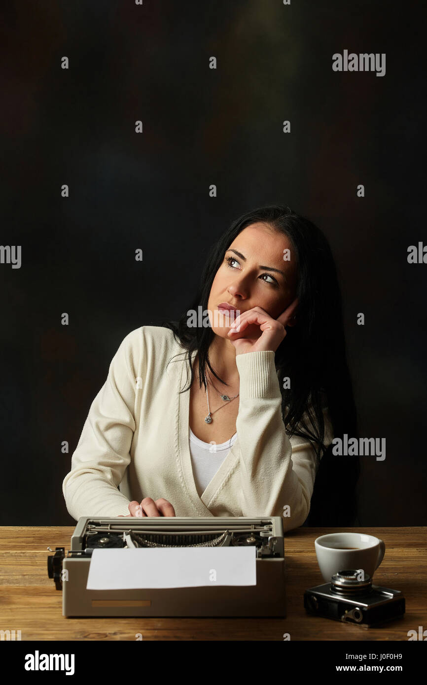 Woman writing on a typewriter Stock Photo - Alamy