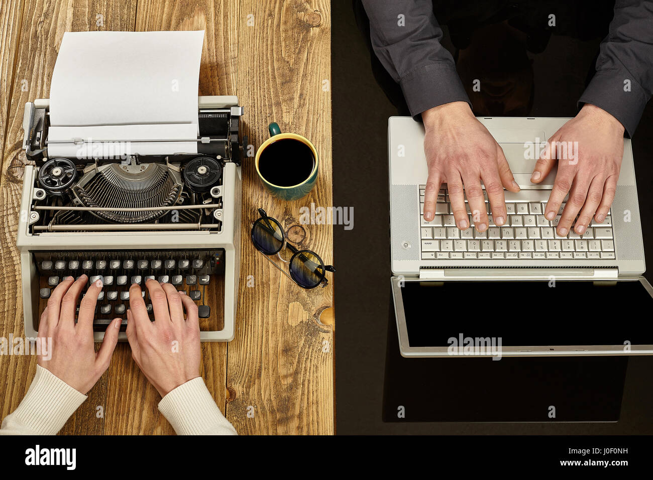 Woman writing on a typewriter and a man working on a laptop.Closeup to ...