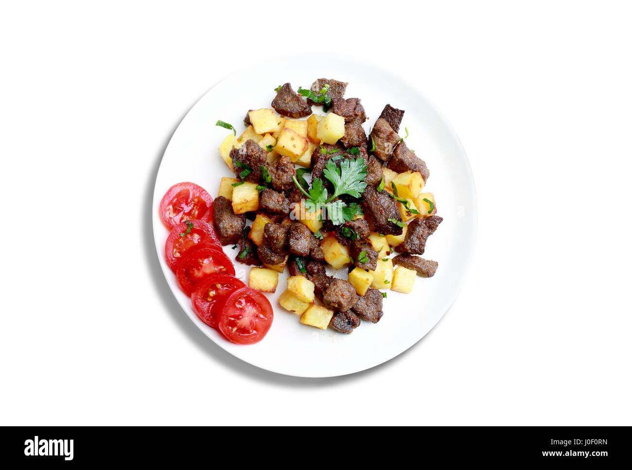 fried liver cubes with potatoes and tomatoes Stock Photo - Alamy