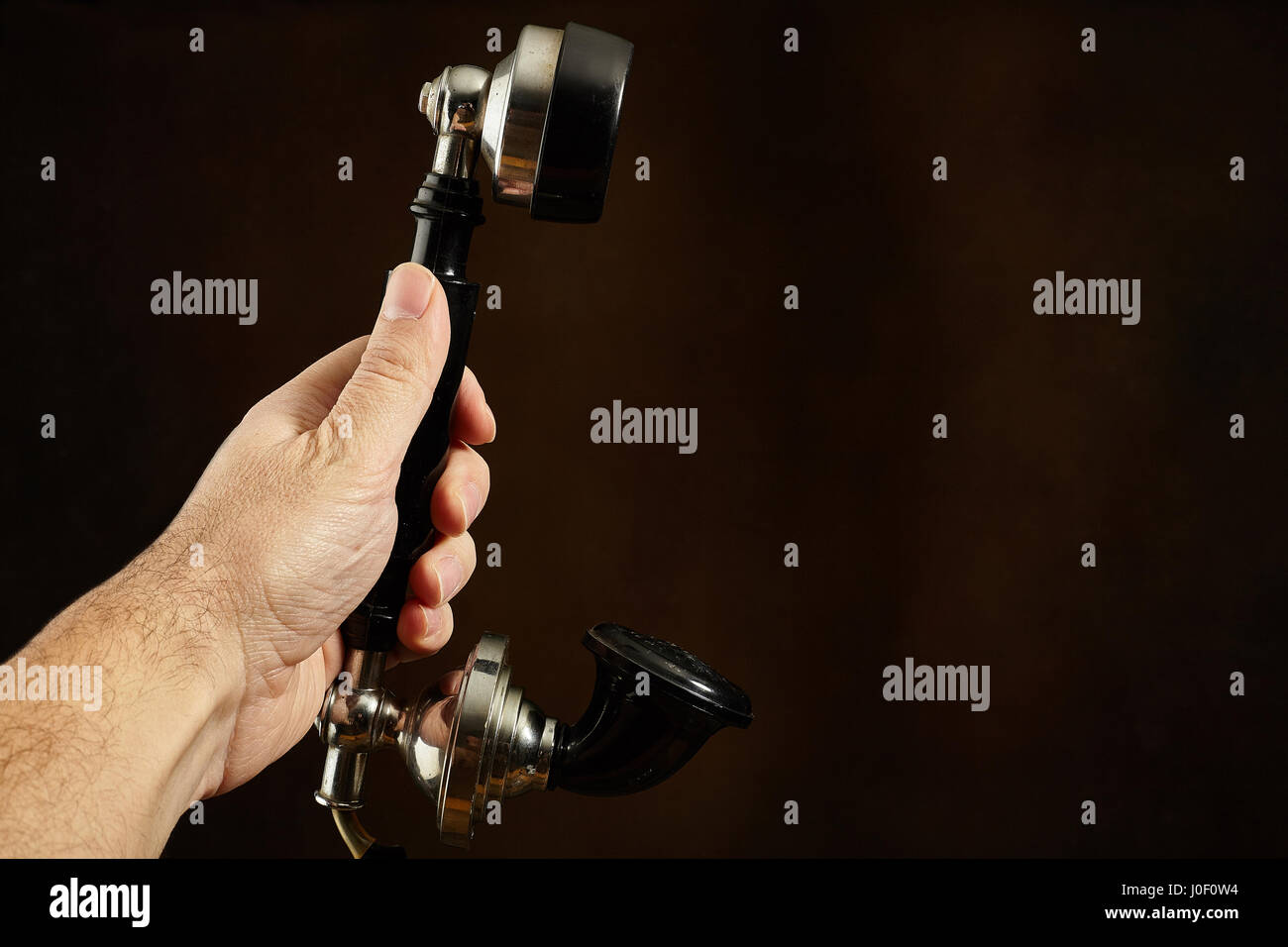 Man's hand holding speaker of telephone Stock Photo - Alamy