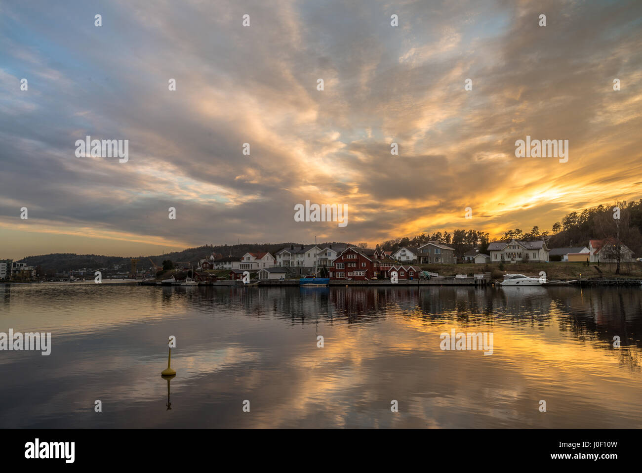 Sun setting over Porsgrunn city and river with an explosion of light ...