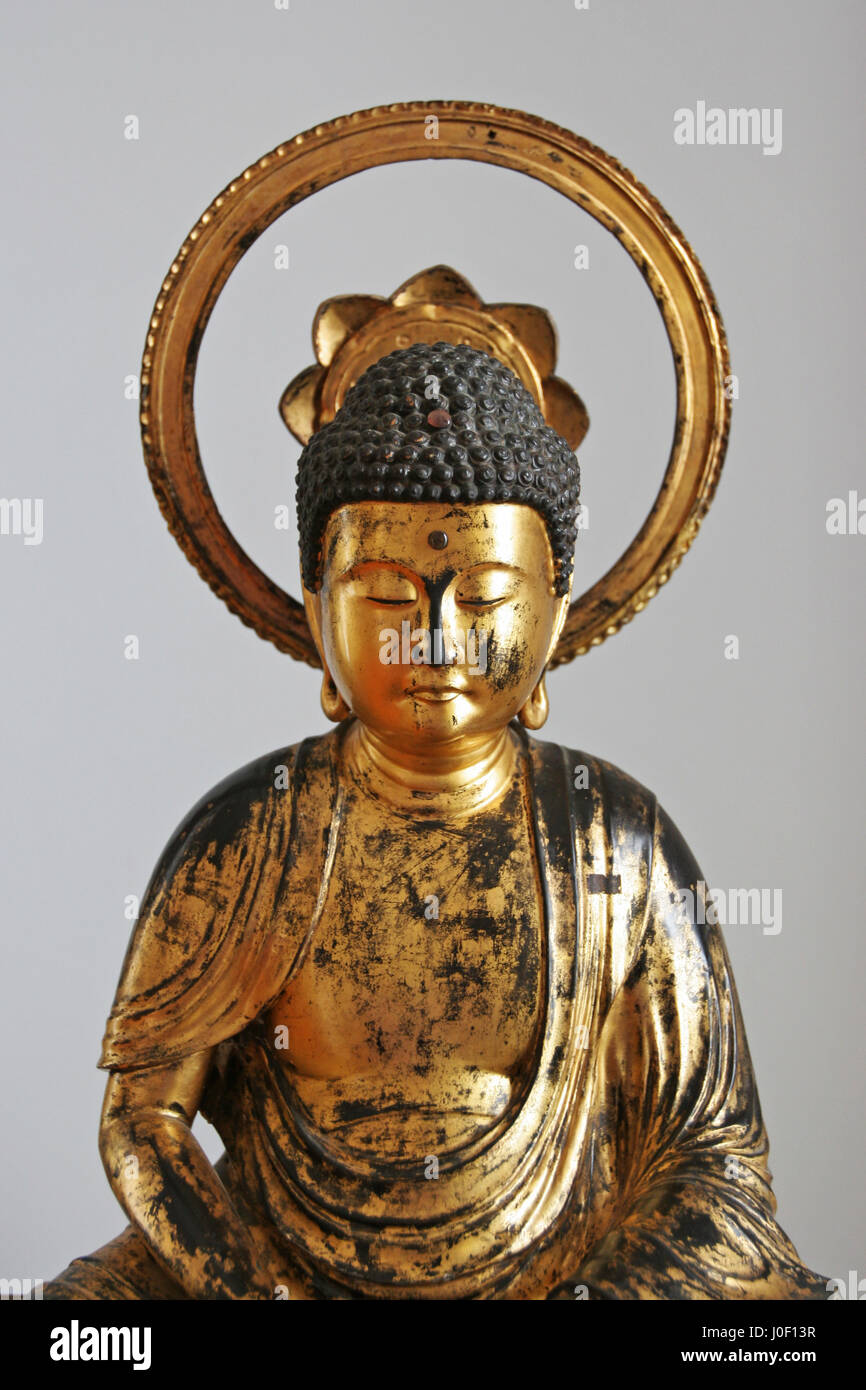Buddha old statue of golden color Stock Photo - Alamy