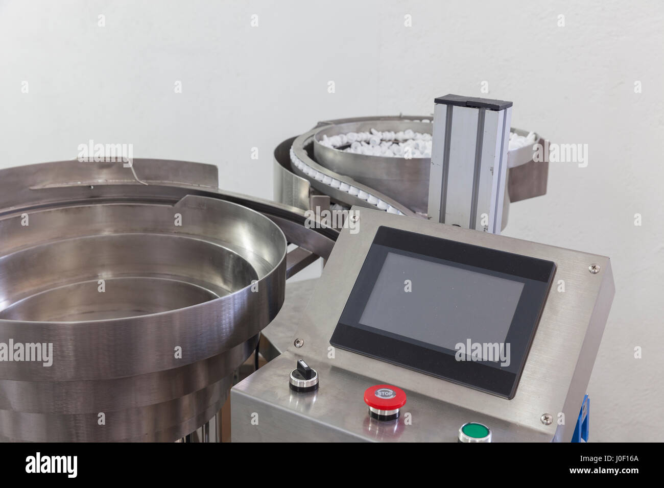 machine for automatically placing plastic lids on bottles Stock Photo ...