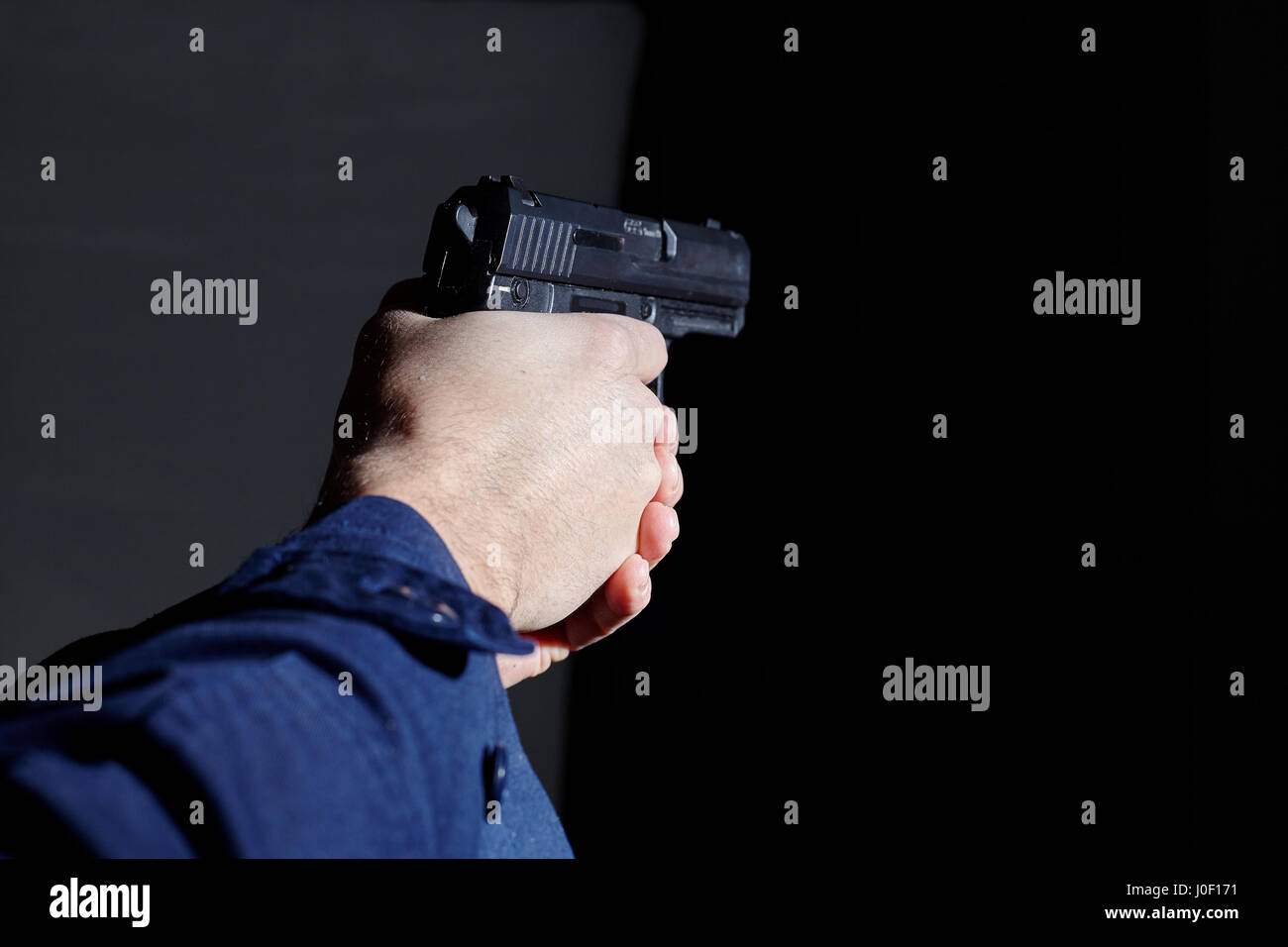 Closeup view of police officer's hands aiming with gun Stock Photo - Alamy