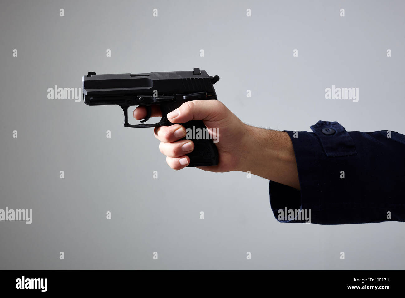 Mans hand holding gun hi-res stock photography and images - Alamy