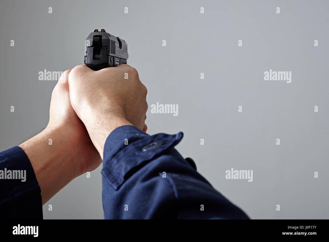 Closeup view of police officer's hands aiming with gun Stock Photo - Alamy