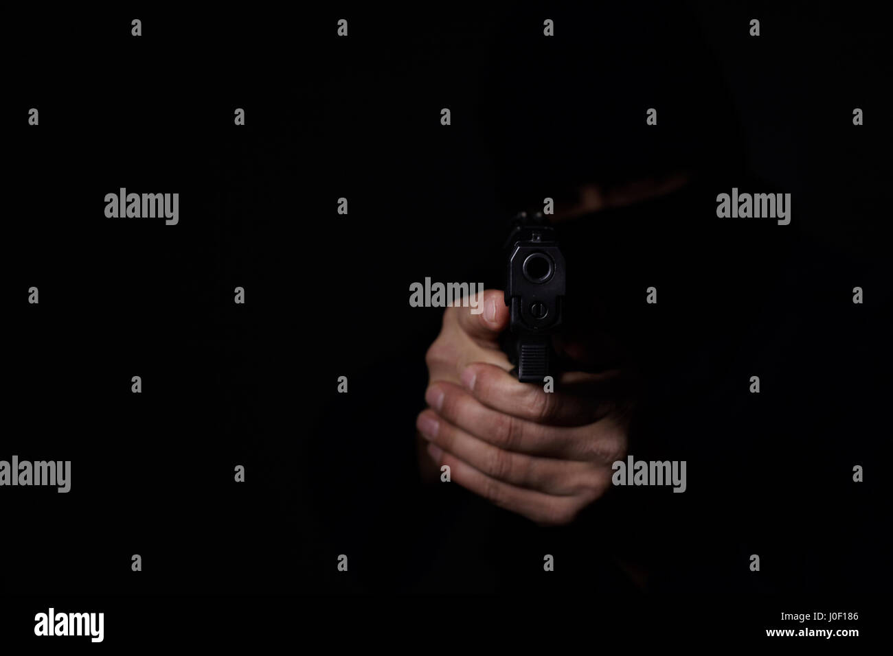 Closeup view of man's hands aiming with gun Stock Photo - Alamy