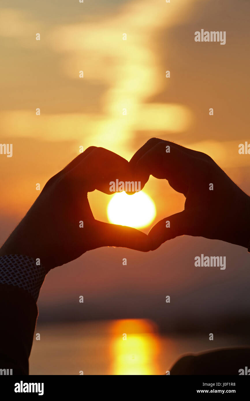 Heart shape silhouette on a beautiful sunset Stock Photo - Alamy