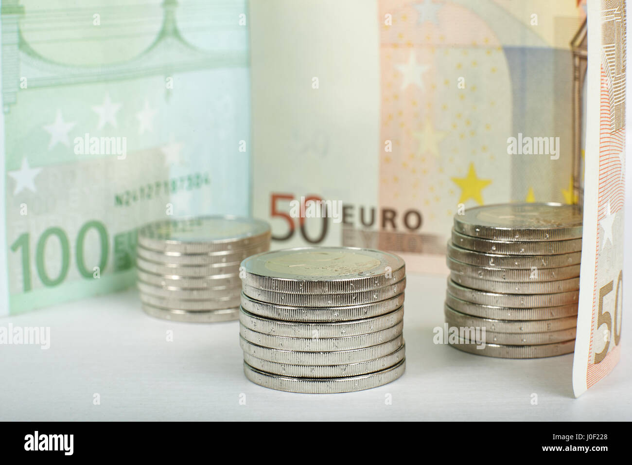Euro coins stacks and banknotes as background Stock Photo - Alamy
