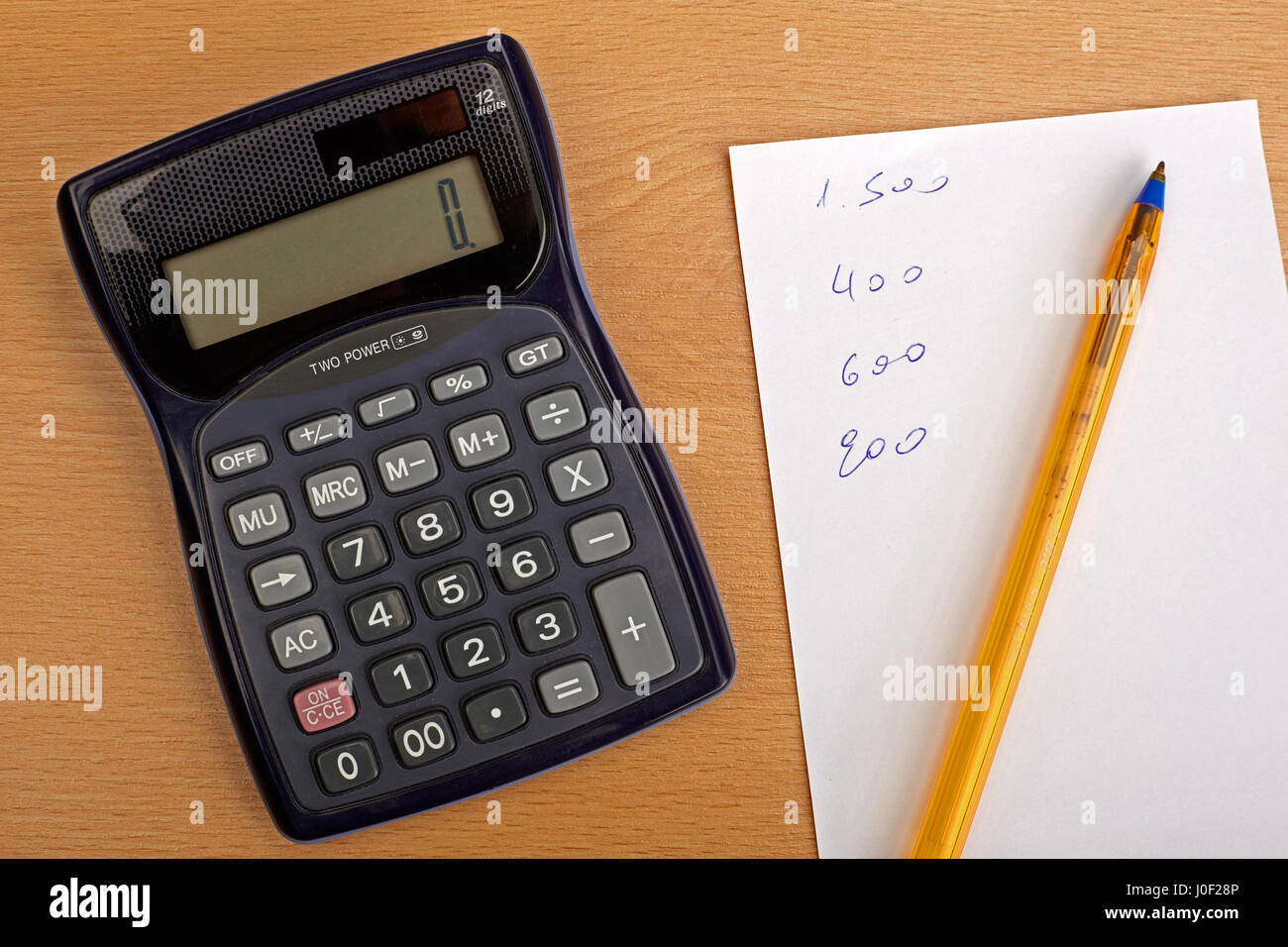 Calculator,note paper and pen on wooden table Stock Photo - Alamy